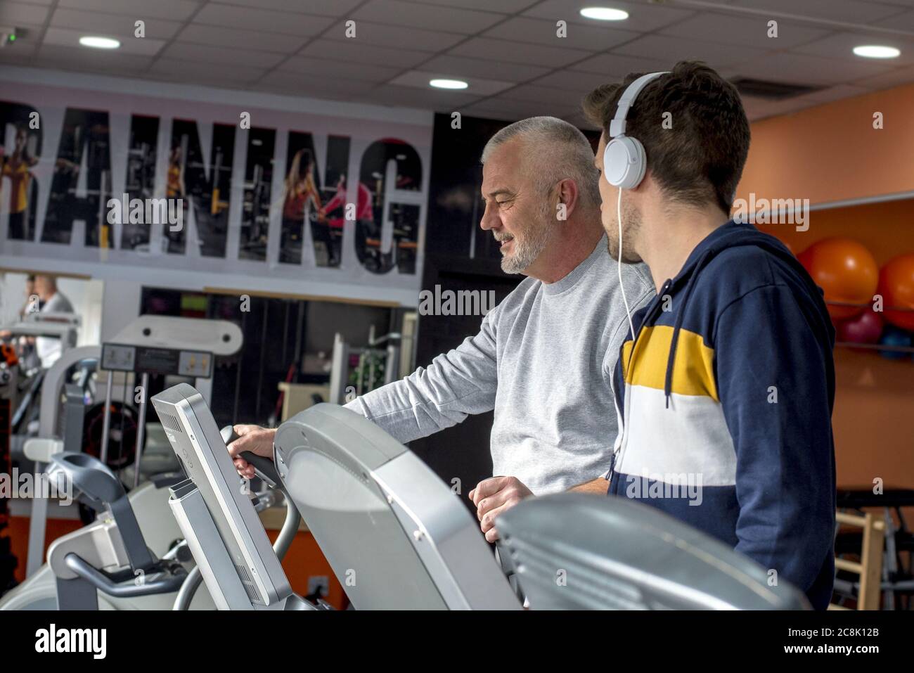 People exercising in a gym indoors and the sunlight falls out of the ...