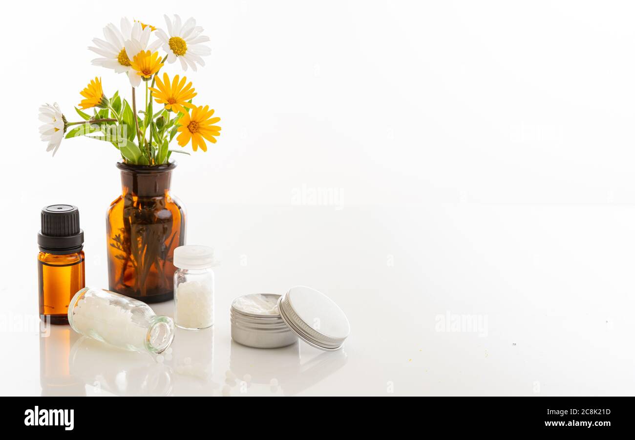 Alternative herbal medicine. Fresh wild flowers, homeopathic globules ...