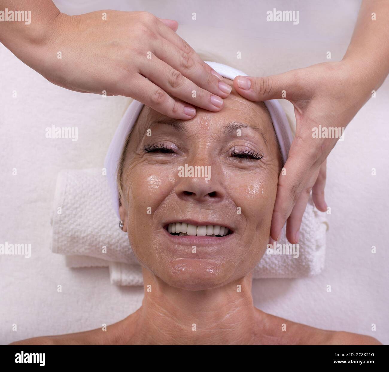 Professional taking care of an ender female's face and skin Stock Photo ...