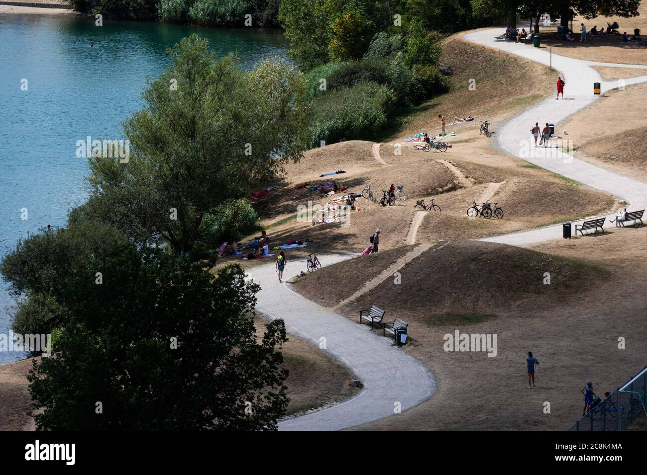 25 July 2020, Baden-Wuerttemberg, Freiburg: People lie on the Flückiger ...
