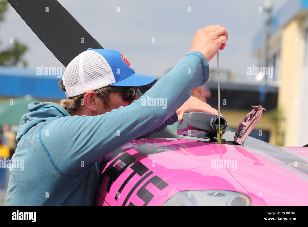 Gera, Germany. 25th July, 2020. Pilot Tim Tibo fills oil into his ...