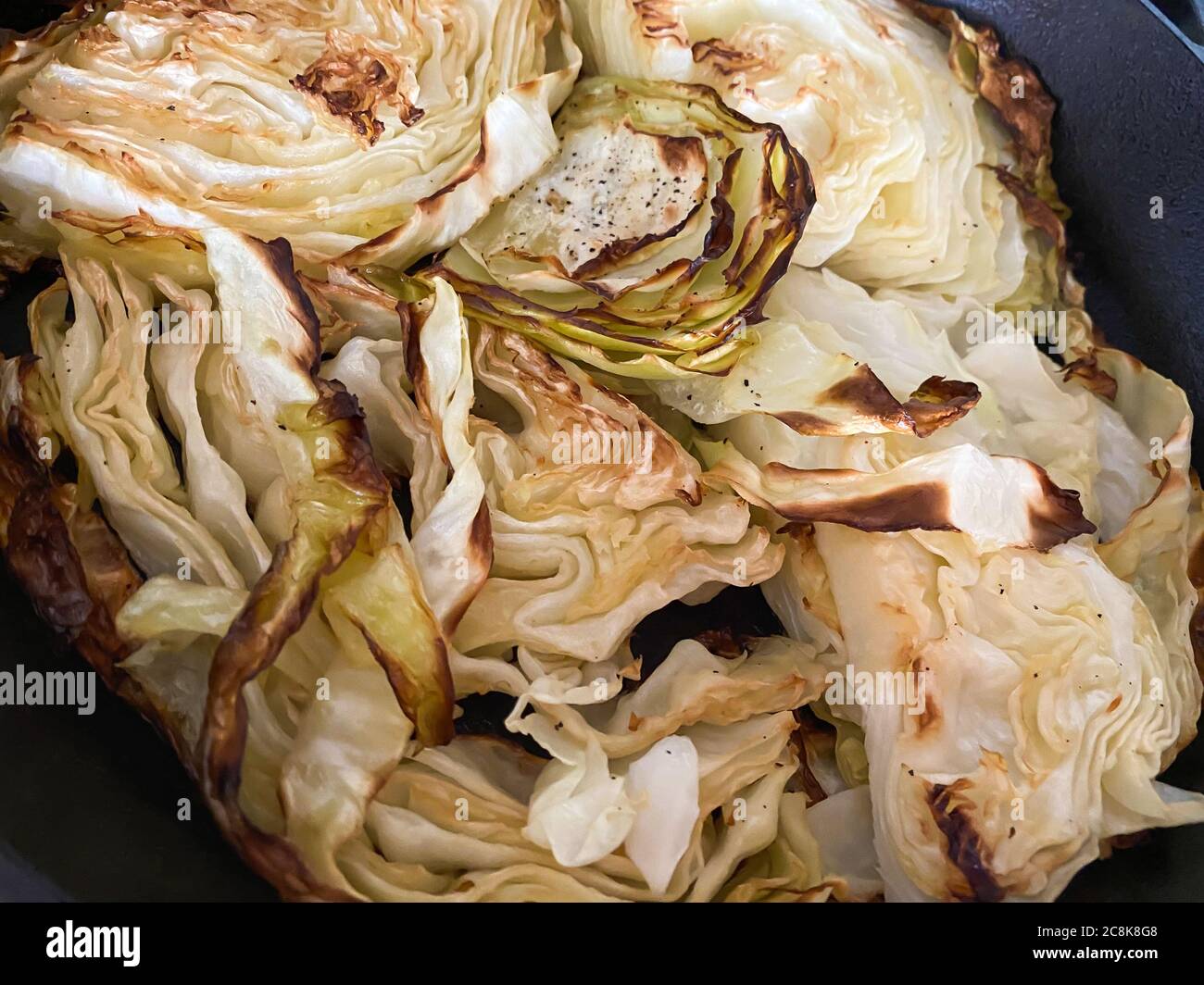 Green cabbage has a nice char on it from being cooked in a cast iron ...