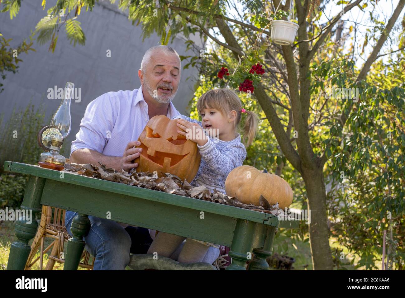 Happy family carving pumpkin together and enjoying a day together Stock ...