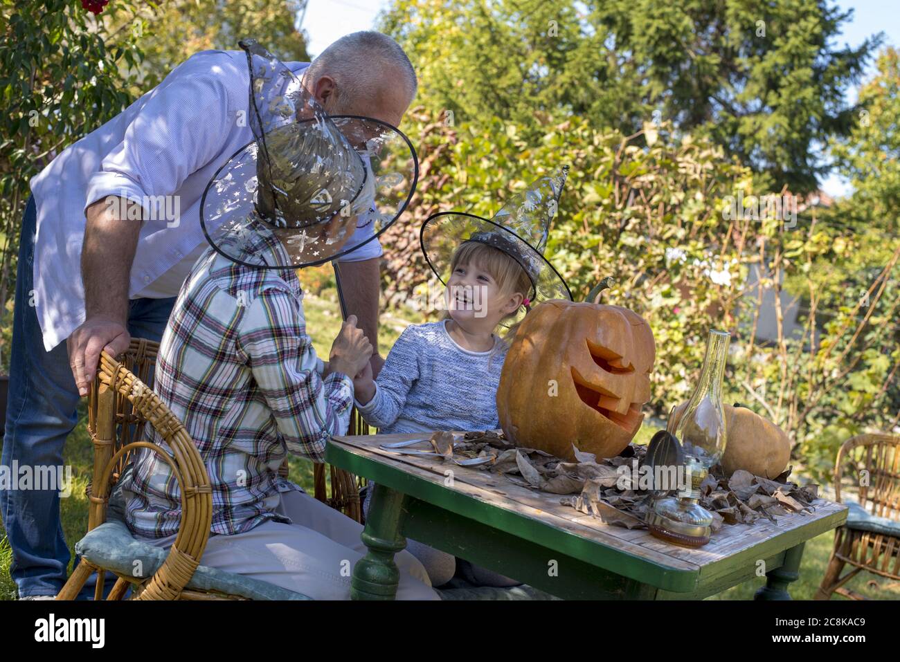 Happy family carving pumpkin together and enjoying a day together Stock ...