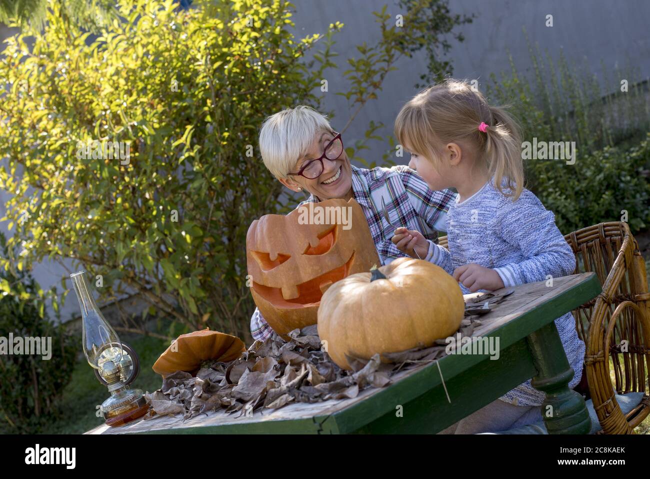 Happy family carving pumpkin together and enjoying a day together Stock ...