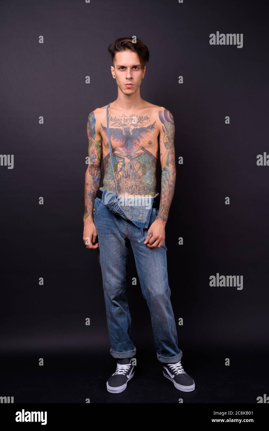 Young handsome rebellious man shirtless against black background Stock ...