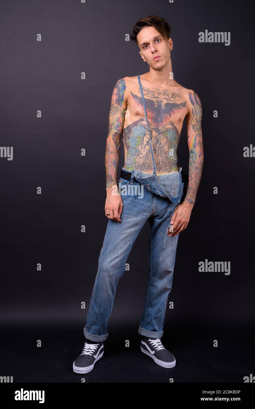 Young handsome rebellious man shirtless against black background Stock ...