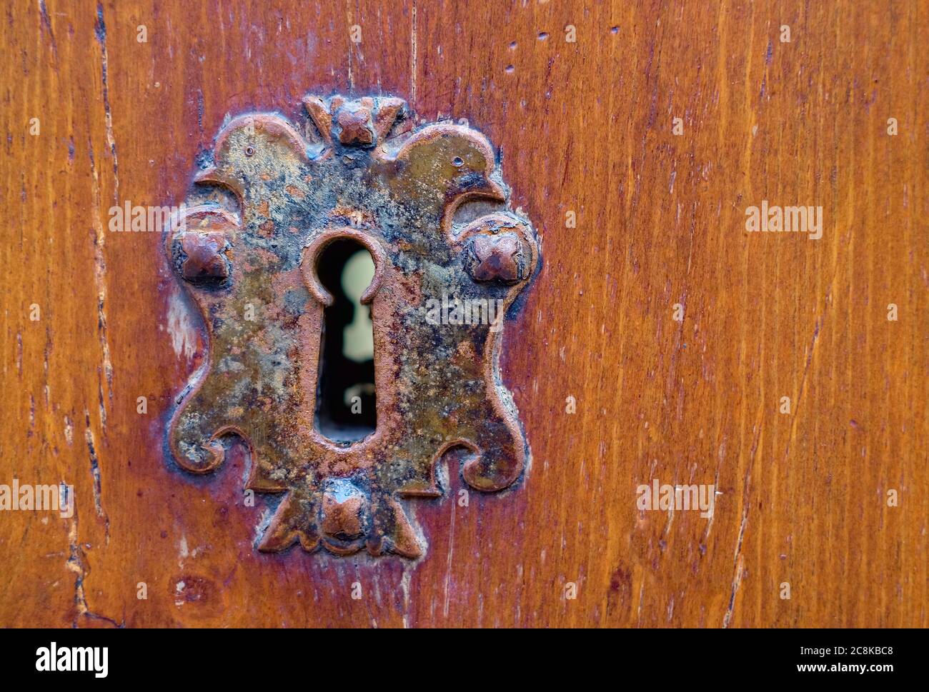 Very graphic decorative key hole in a wooden door Stock Photo - Alamy