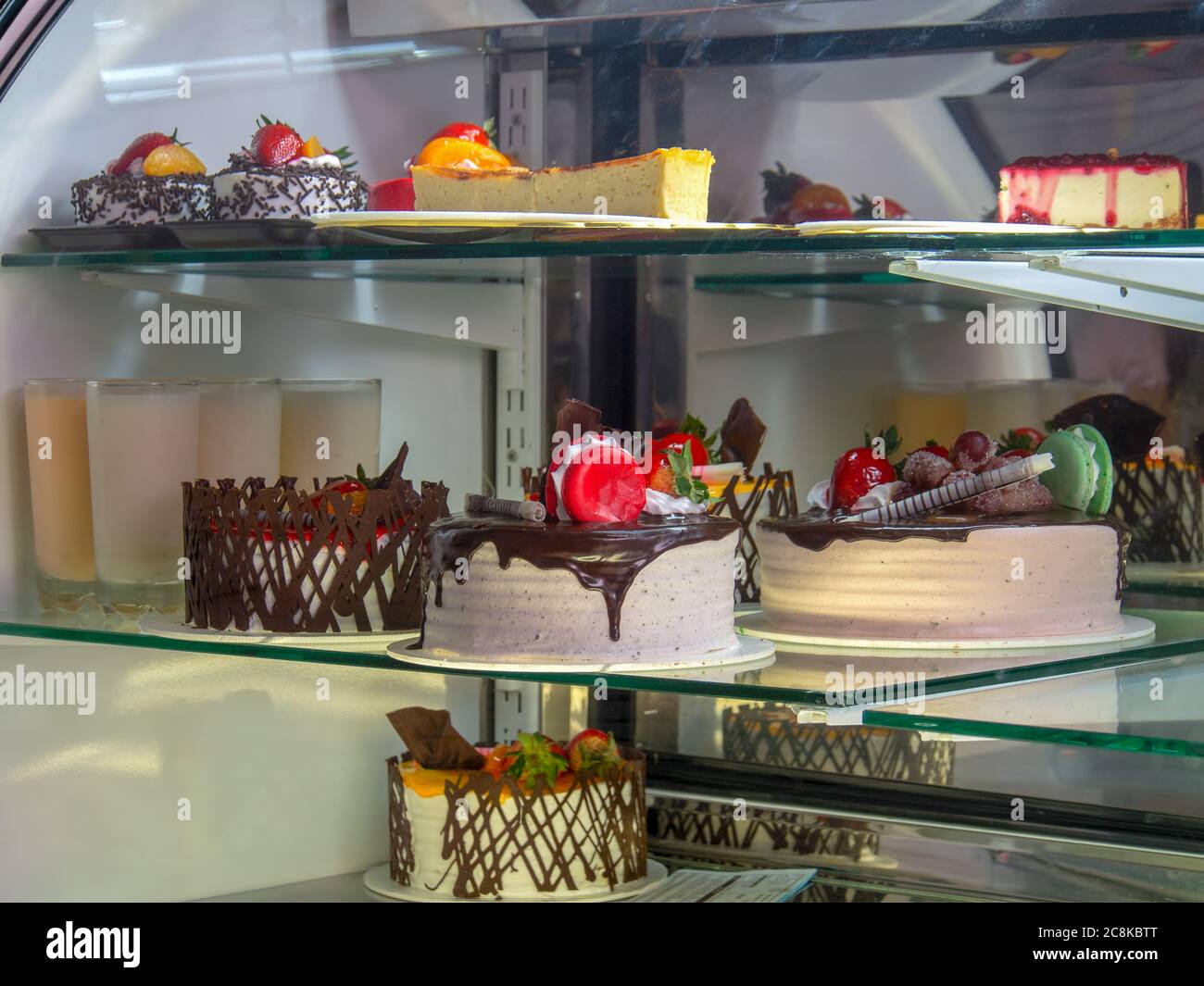 Some colorful and very decorated cakes in a showcase refrigerator Stock ...