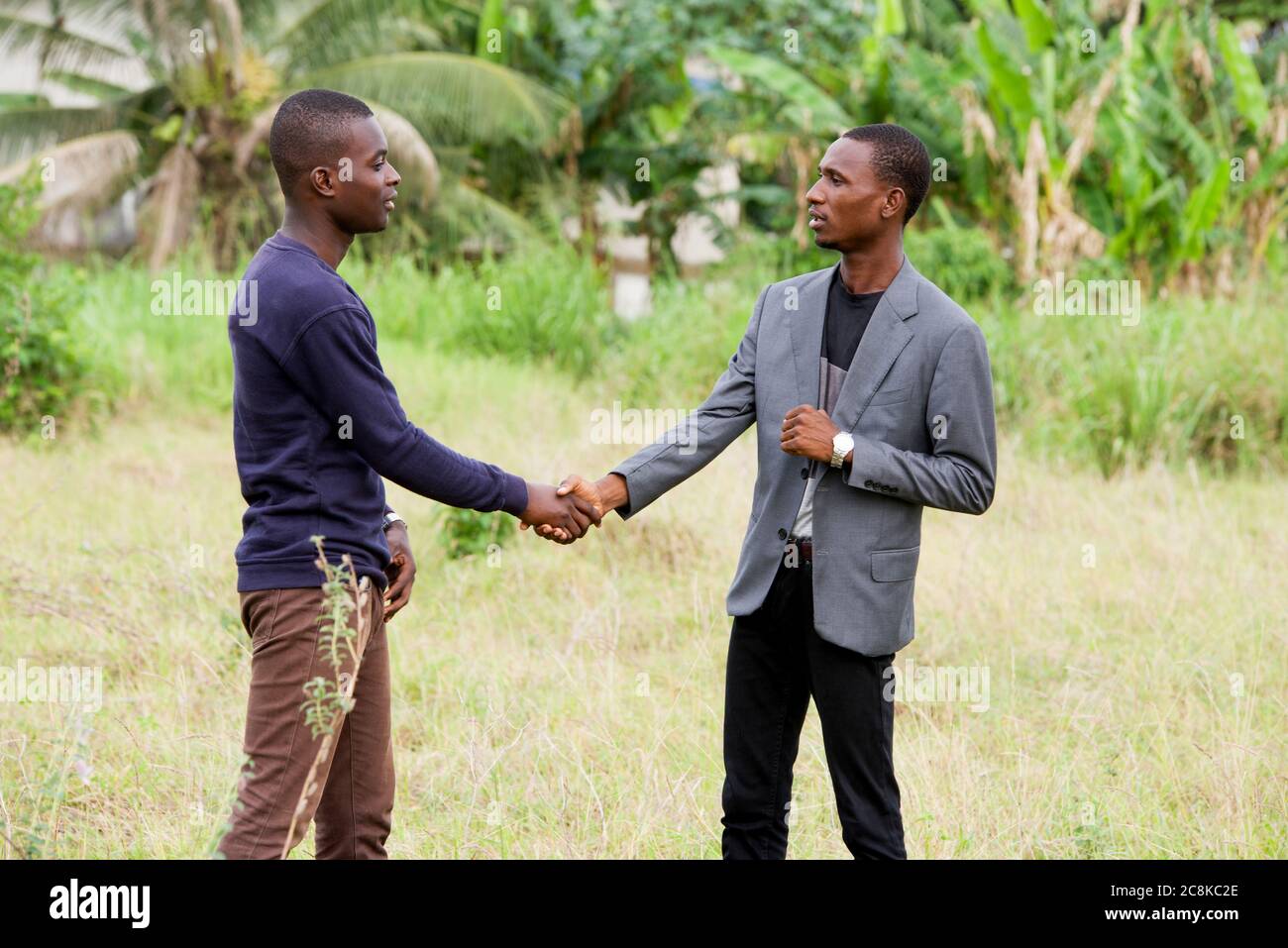 Two people greet other handshake hi-res stock photography and images ...