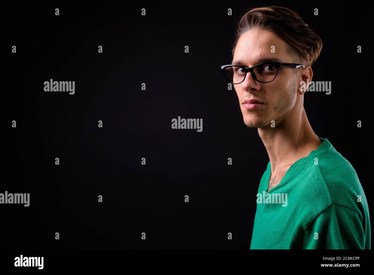 Young handsome rebellious man against black background Stock Photo - Alamy