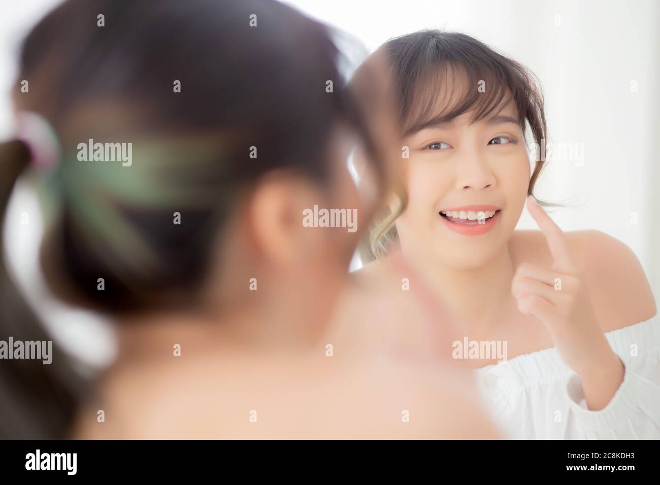 Beautiful face young asian woman with happy smiling and looking mirror ...