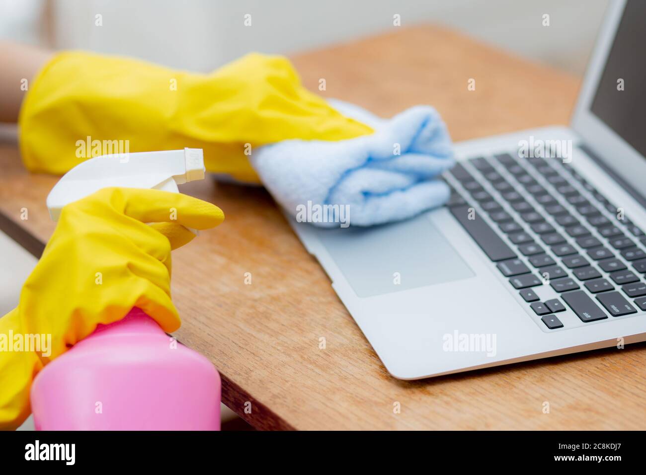 Hand of young asian woman cleaning and wipe laptop computer with ...