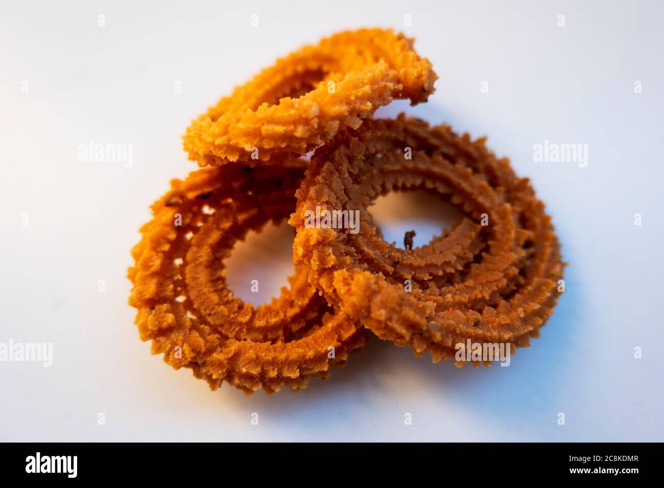 a closeup view of traditional homemade muruku snacks isolated on white ...