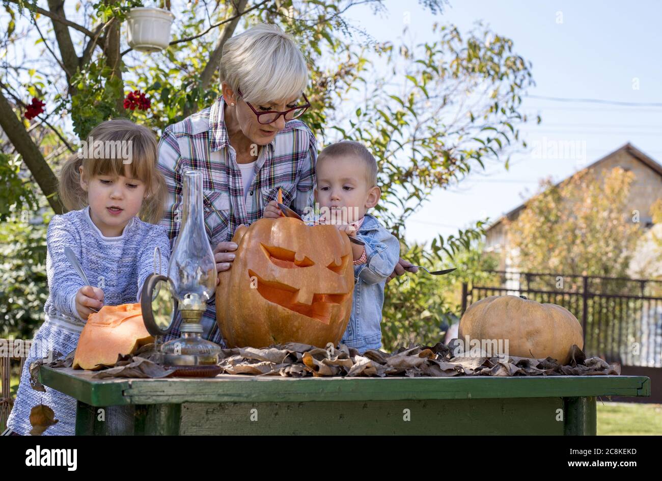 Happy family carving pumpkin together and enjoying a day together Stock ...
