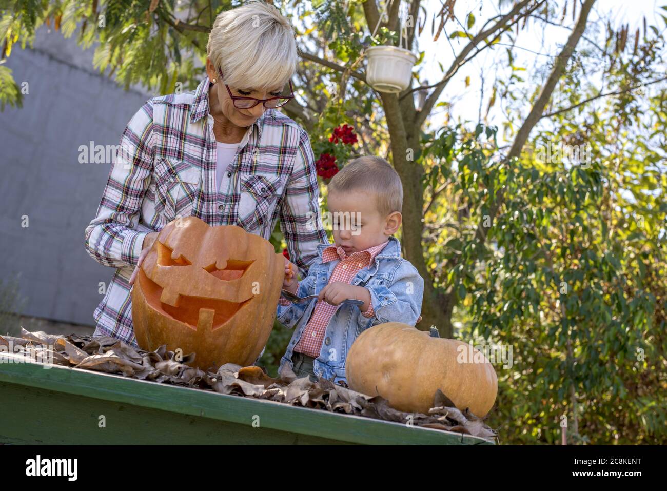 Happy family carving pumpkin together and enjoying a day together Stock ...