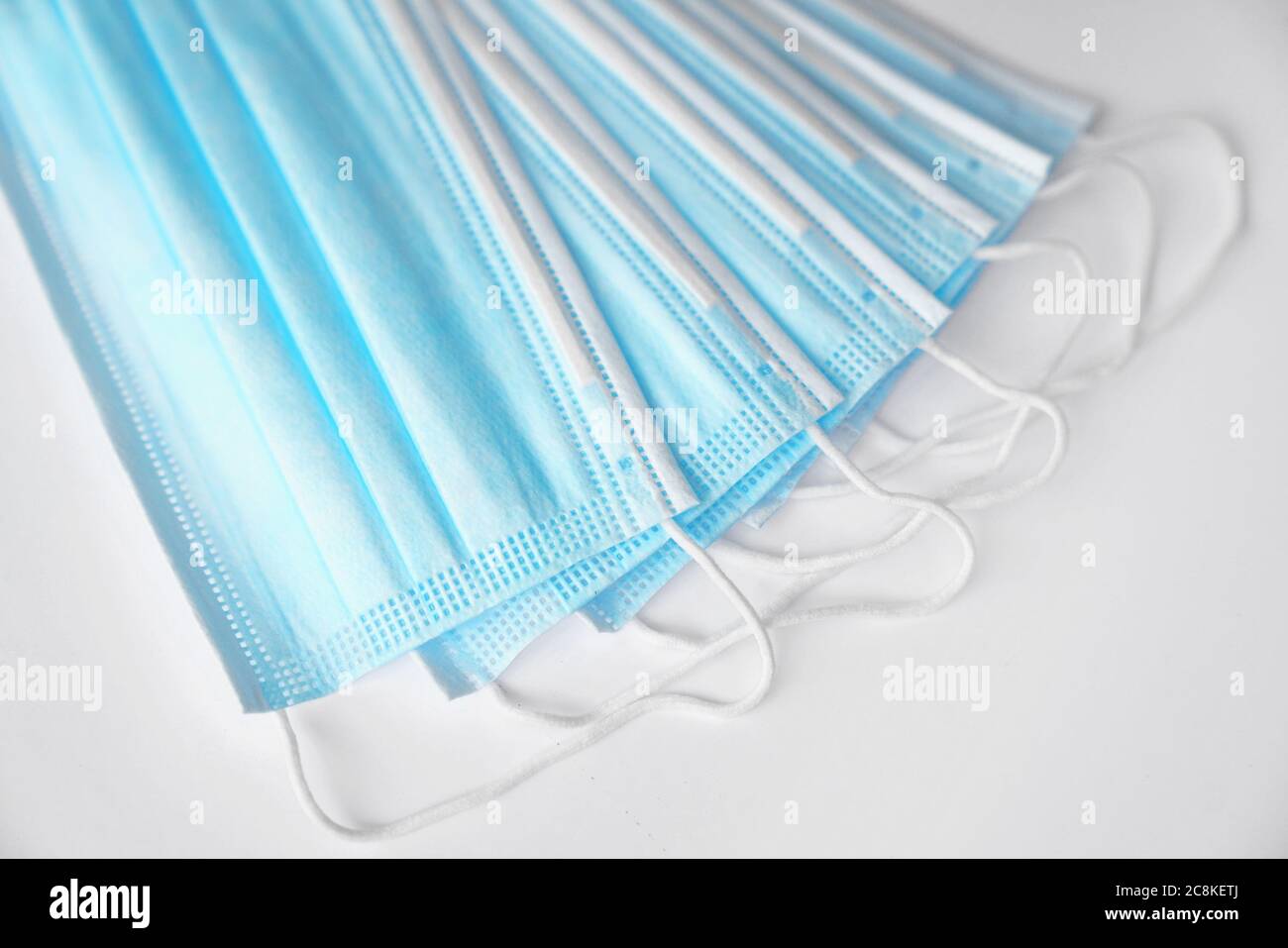 Blue medical masks lie on a white table - face mask against bacteria ...