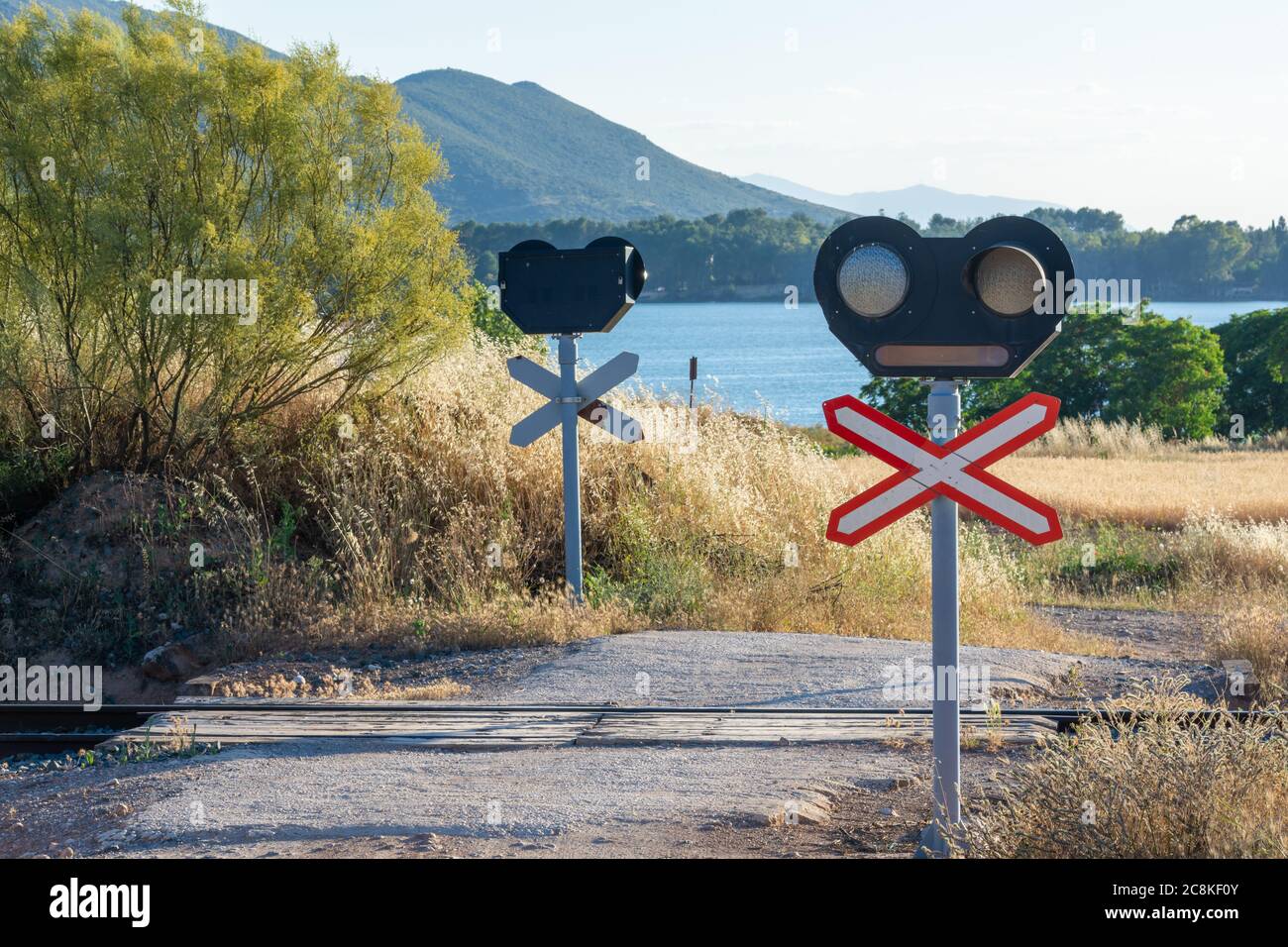Warning signs on a road that crosses the train tracks Stock Photo - Alamy