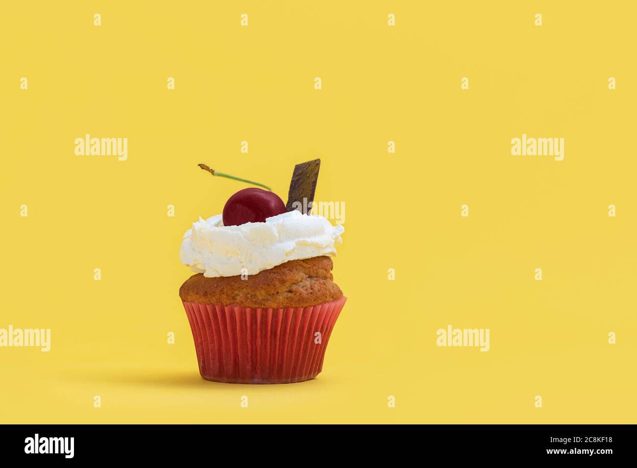 Festive colorful yellow background with cupcake decorated with ...