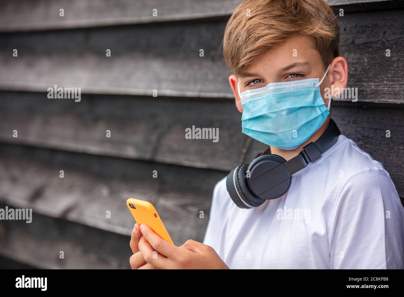 Boy teenager teen male child wearing a face mask outside during the ...