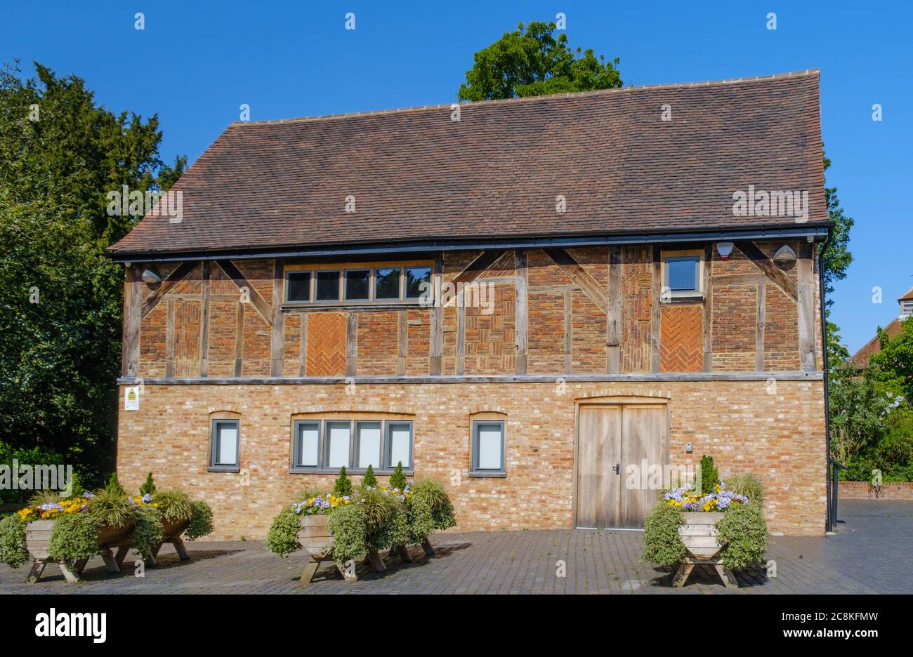 The Stables, 17th century timber framed building, with wooden planters ...