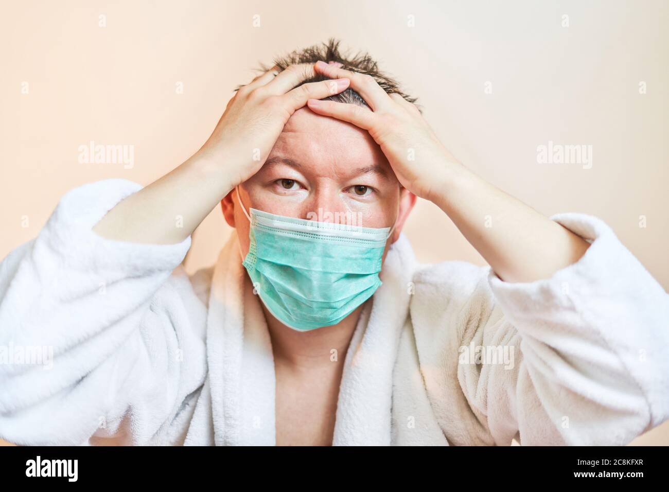 Masked Asian man, grabbed his head, self-isolation, stay at home ...