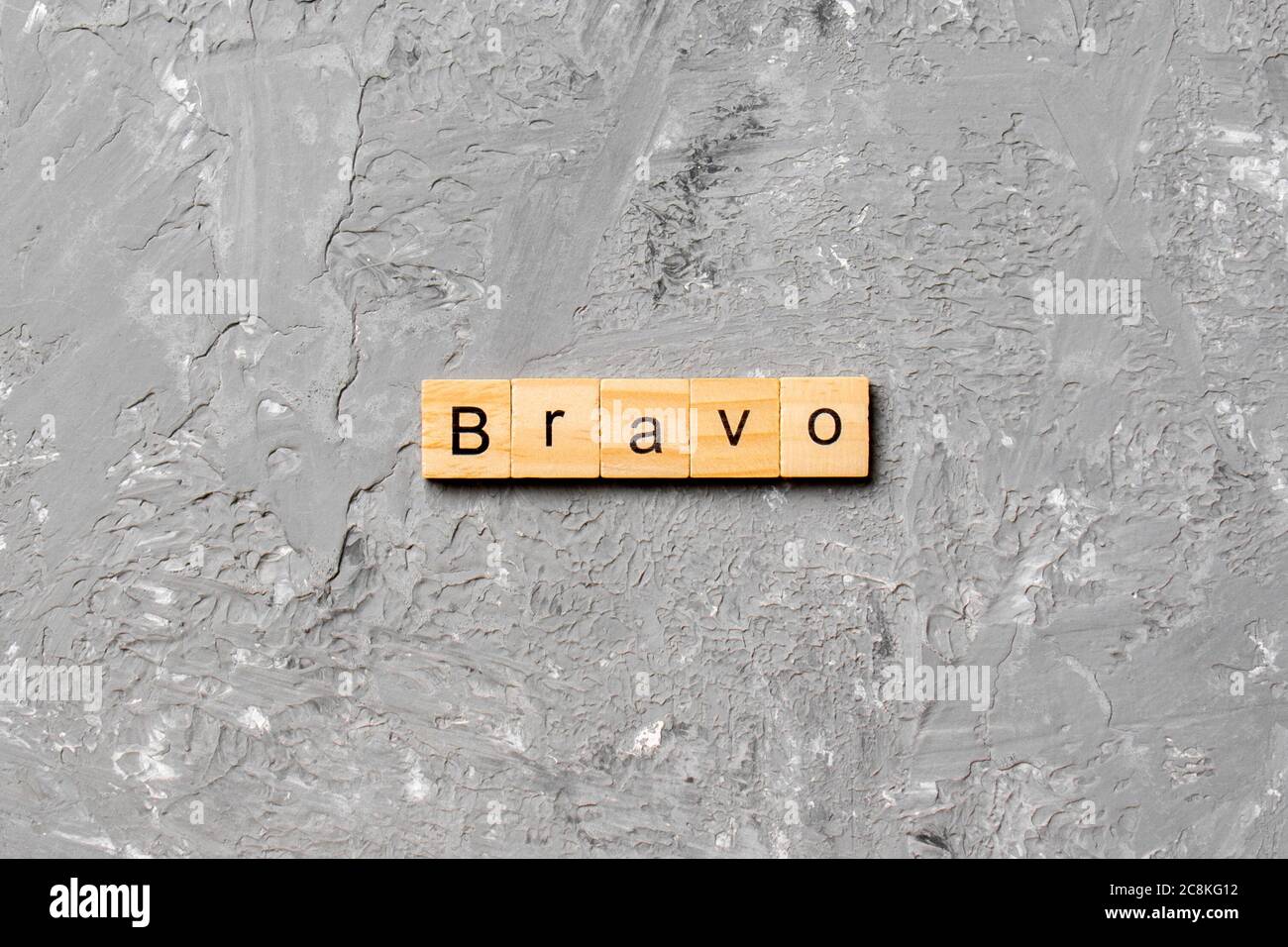 BRAVO word written on wood block. BRAVO text on cement table for your ...