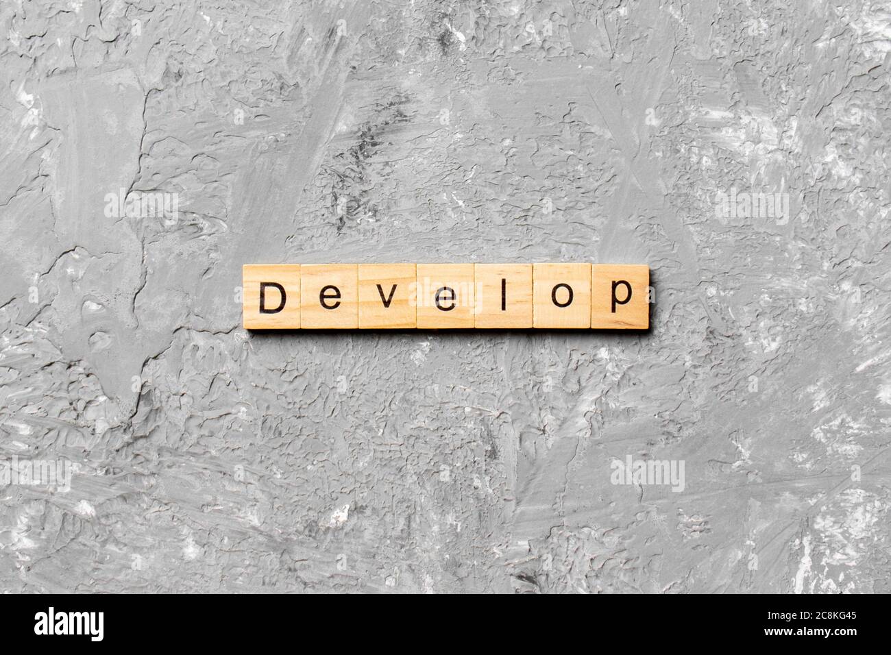 Develop word written on wood block. Develop text on cement table for ...