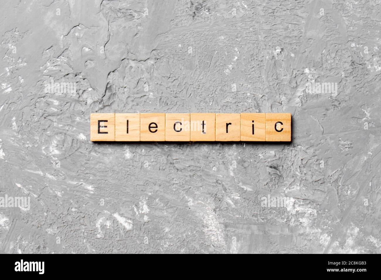Electric word written on wood block. Electric text on cement table for ...