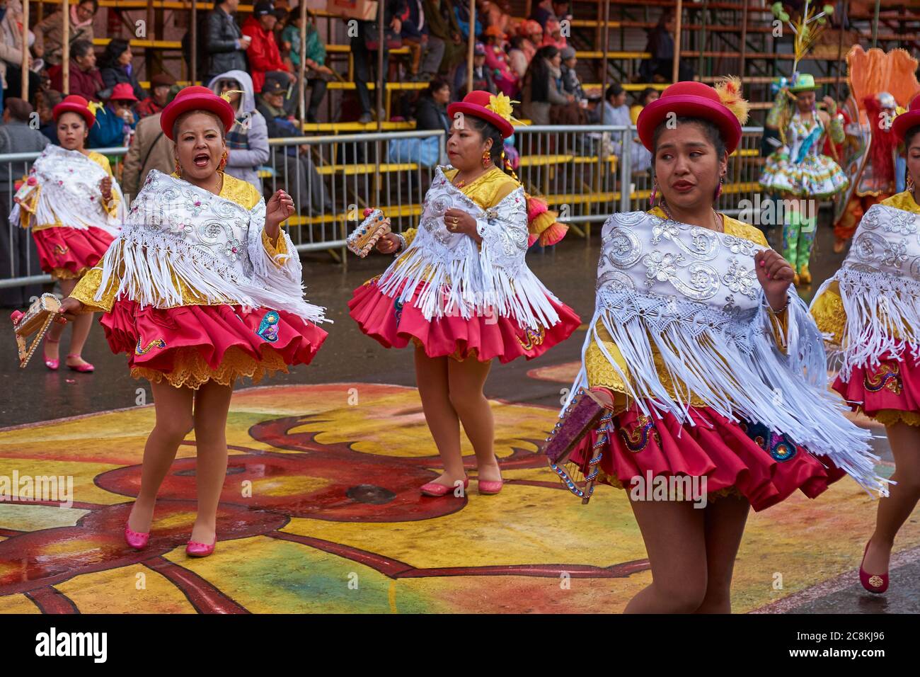 Traditional dancers in colourful costumes parading through the mining ...