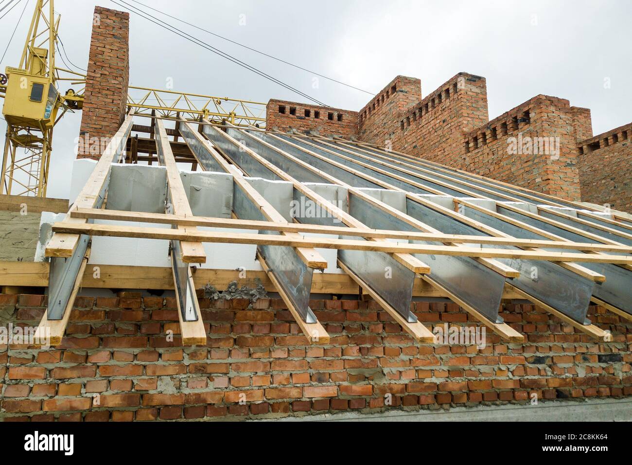 Unfinished brick apartment building with wooden roof structure under ...