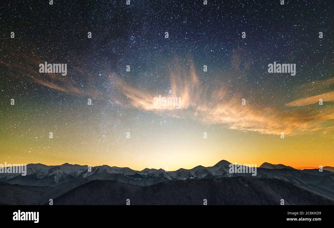 Amazing night mountain landscape with high peaks and bright starry sky ...