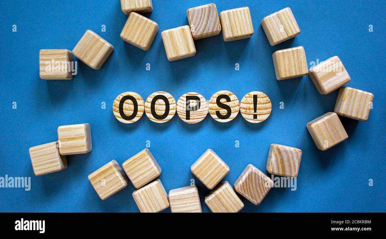 Oops sign on wooden cut circles. Wooden cubes. Beautiful blue ...