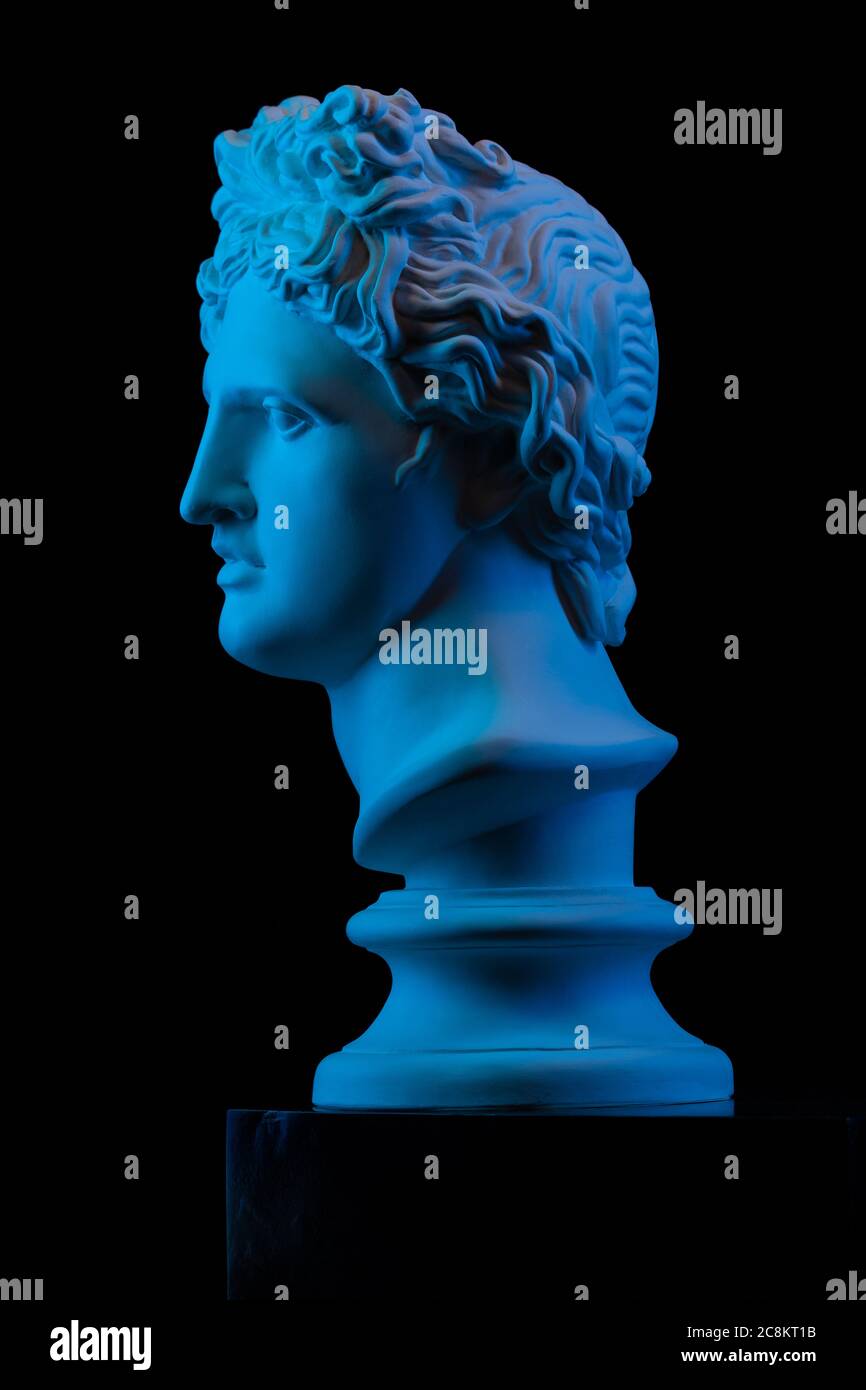 Plaster statue of a bust of Apollo Belvedere in blue local light on a ...