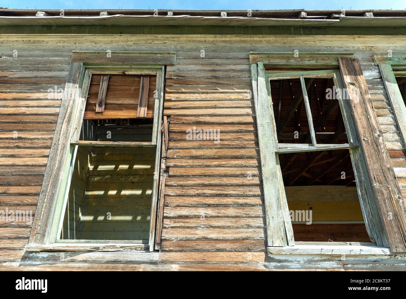 Two empty window frames of an abandoned schoolhouse on the plains of ...