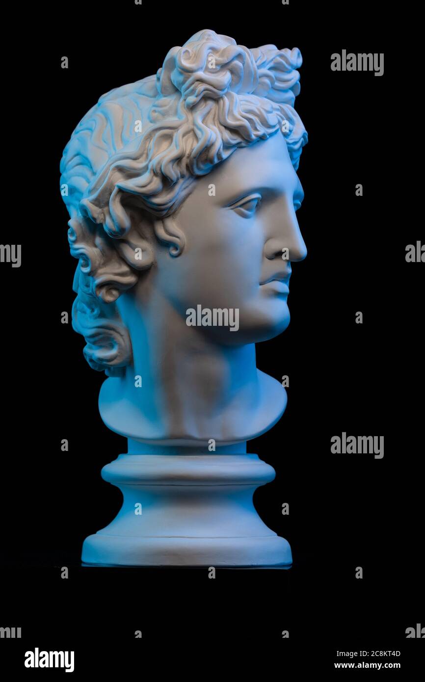 Plaster statue of a bust of Apollo Belvedere in blue local light on a ...