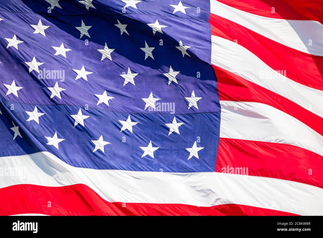 Beautiful American flag waving in the wind, with vibrant red white and ...