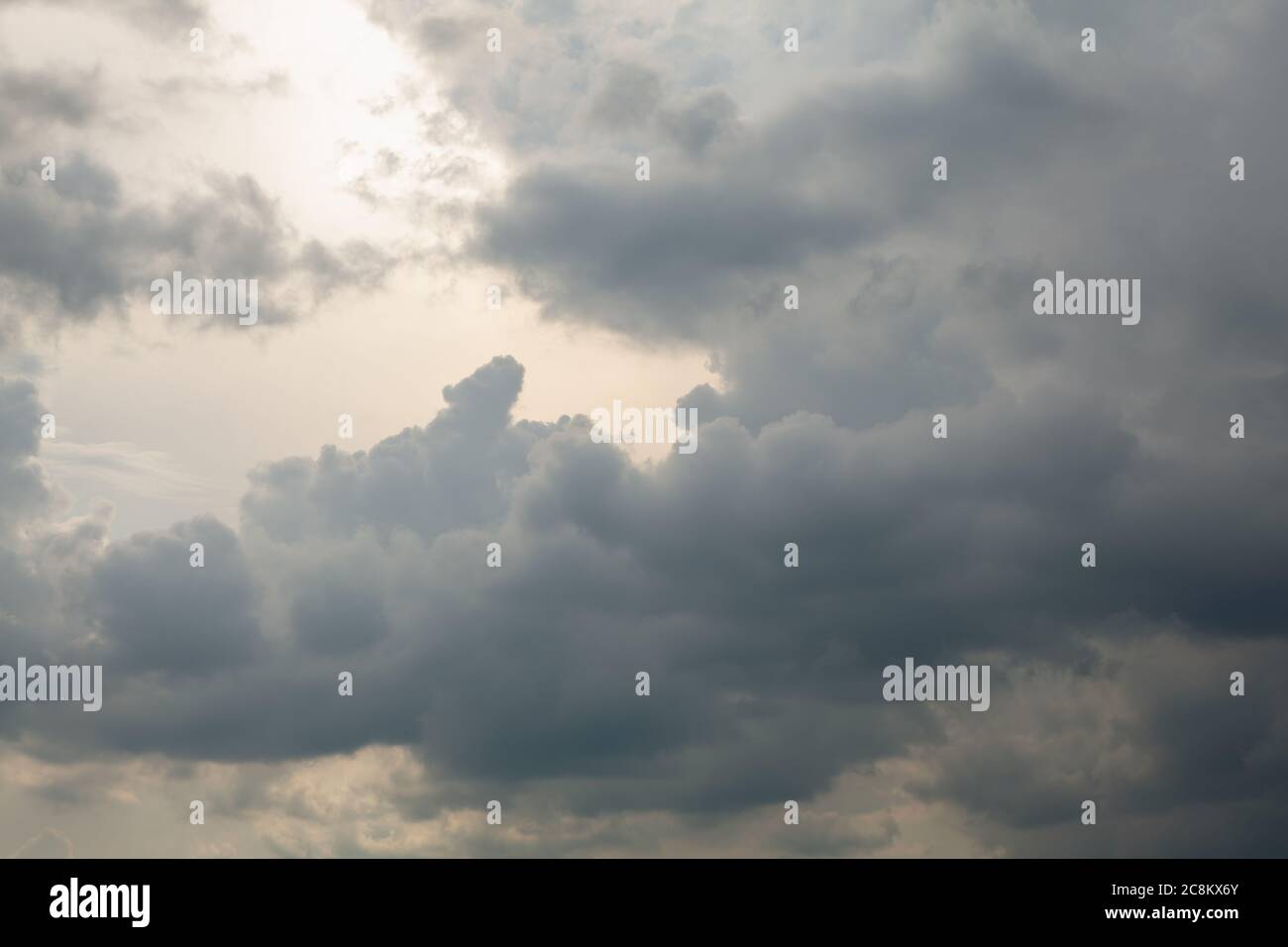 Sun ray through grey clouds . Weather before storm Stock Photo - Alamy