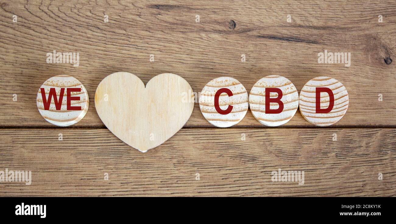 Concept words 'we' and 'cbd' on wooden circles. Wooden heart. Beautiful ...