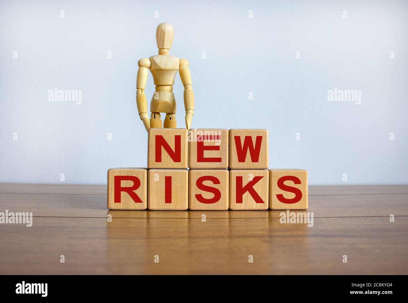 Concept words 'new risks' on cubes on a beautiful wooden table. Wooden ...