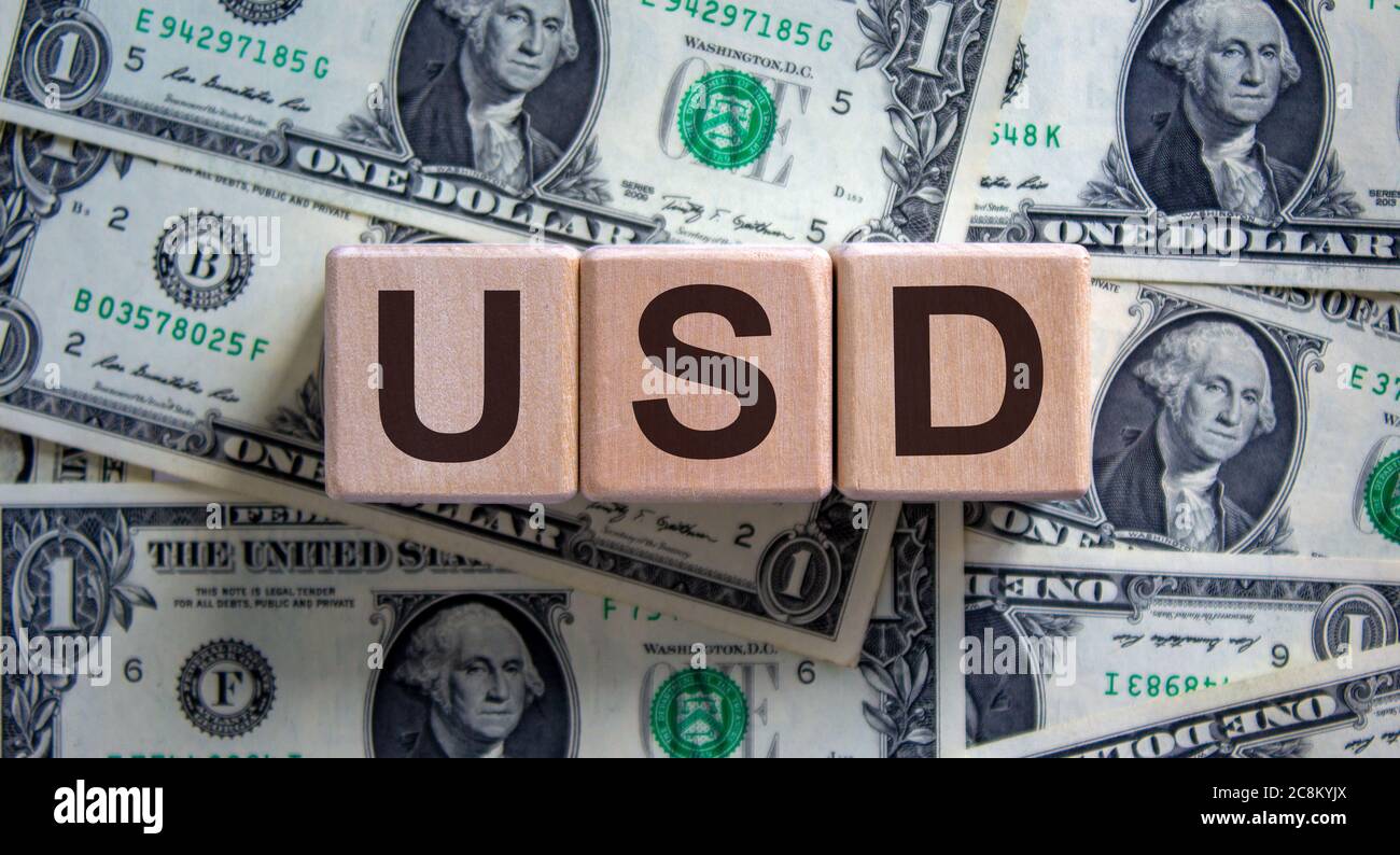 Concept word 'USD' on cubes on a beautiful background from dollar bills ...