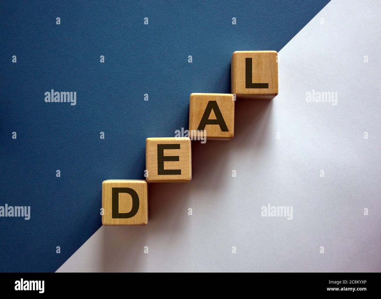Wood block with word 'deal' stacking as step stair on paper blue and ...