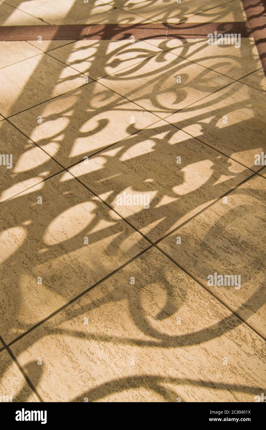 Tiled floor in a shallow focus with shadows. Abstract background with a ...