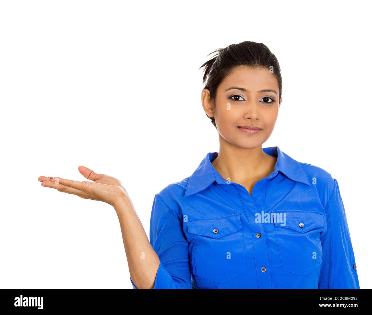 Portrait of happy young smiling woman gesturing pointing to space at ...