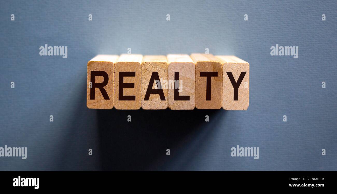 Wooden blocks form the words 'realty'. Beautiful blue background Stock ...