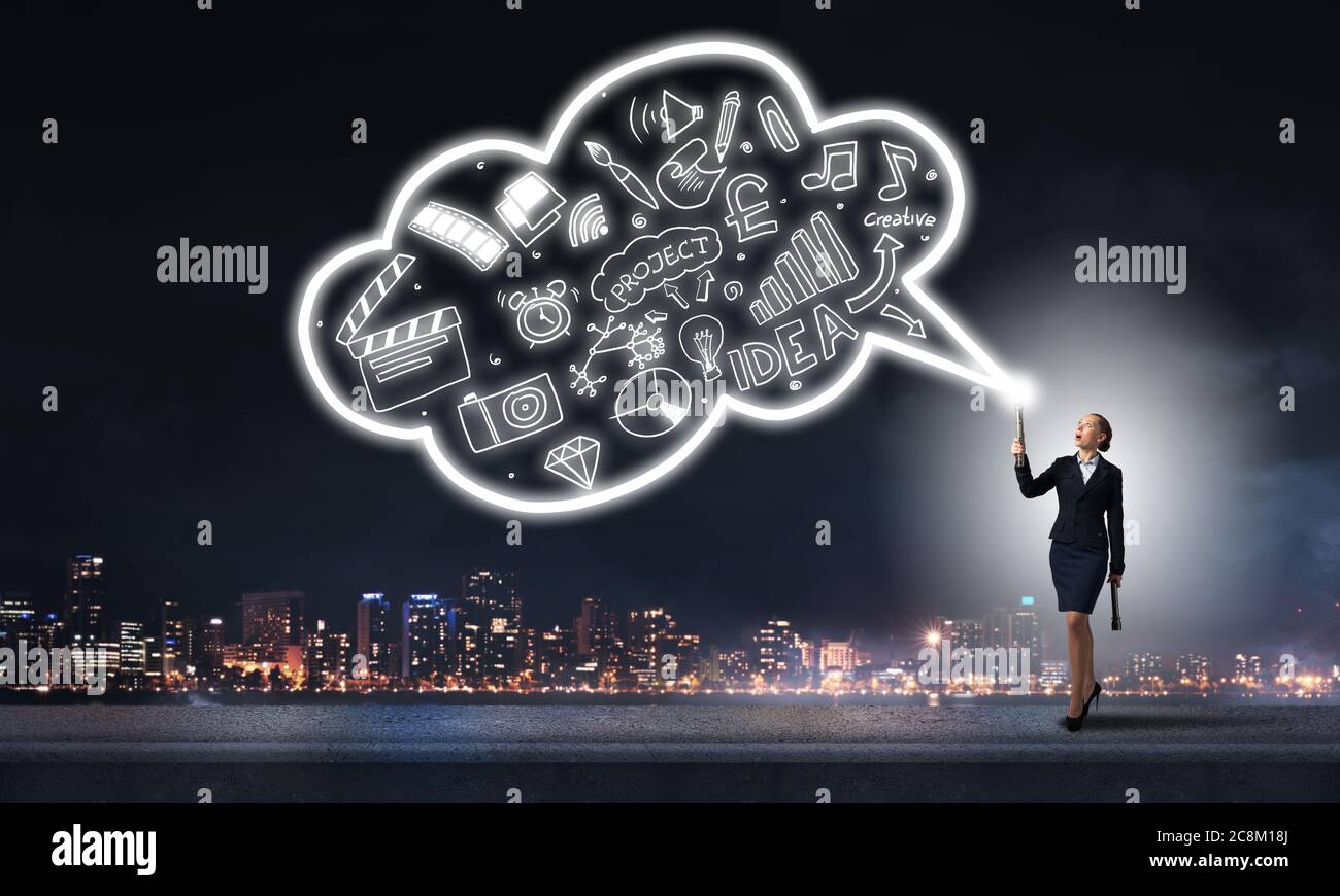 Woman throwing light on her ideas Stock Photo - Alamy