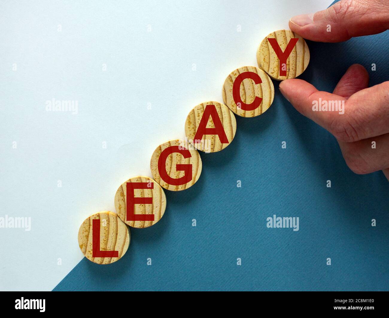 Wood circles with word 'legacy' stacking as step stair on paper blue ...