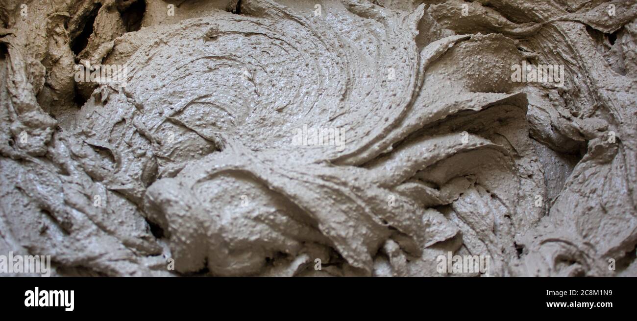 Gypsum plaster in a bucket, prepared for application on the wall ...