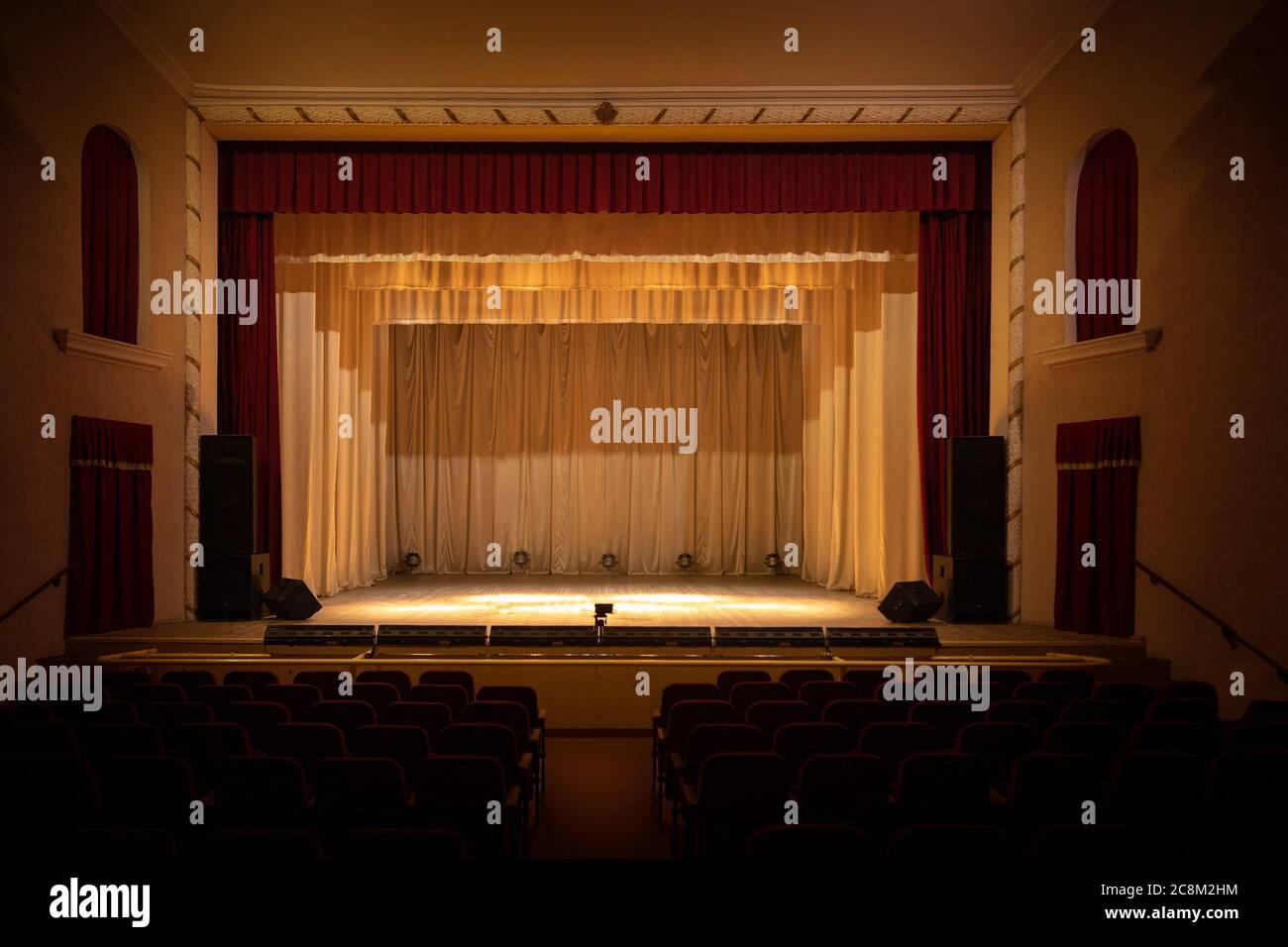 An empty stage of the theater, lit by spotlights and smoke before the ...