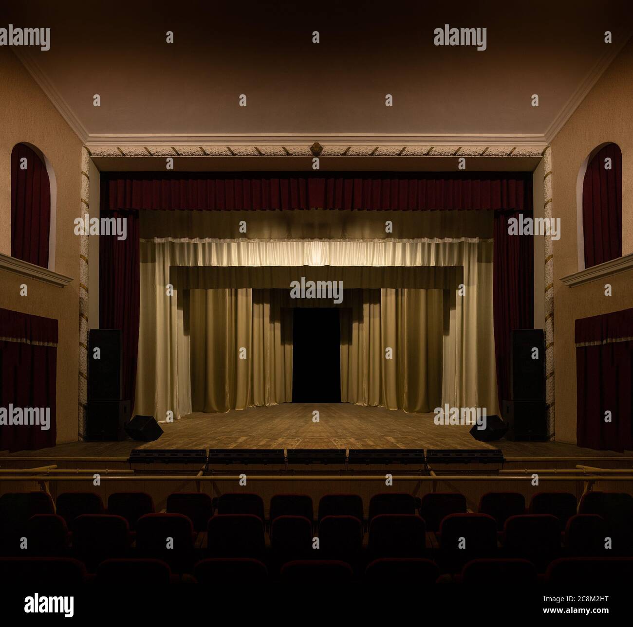 An empty stage of the theater, lit by spotlights and smoke before the ...